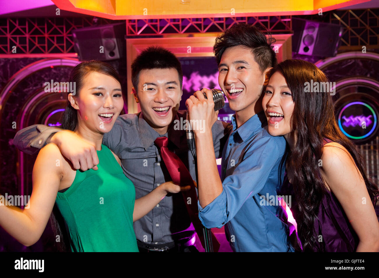 Group of young people gathering in KTV Stock Photo - Alamy