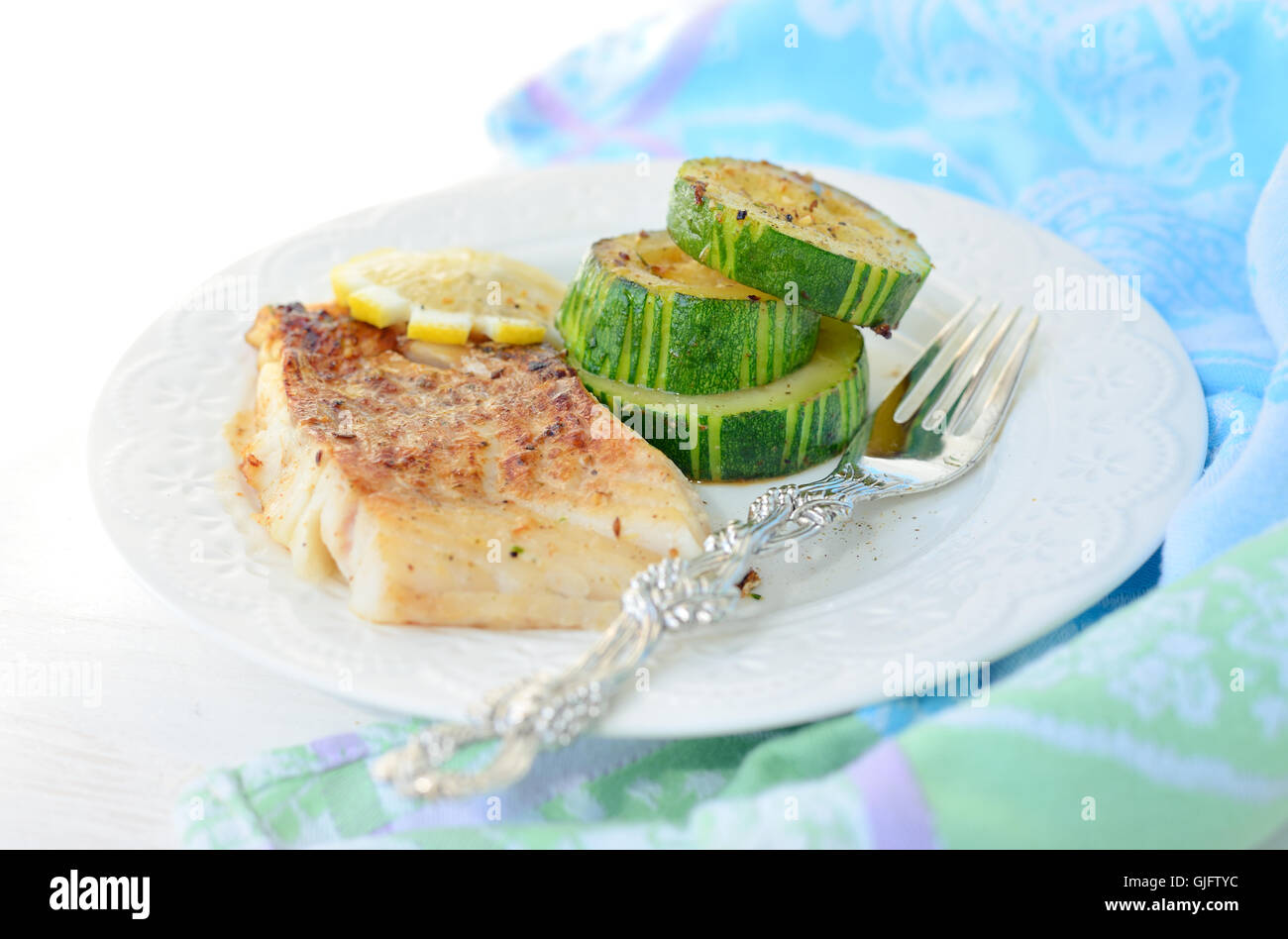 Grilled fish (cod) with zucchini Stock Photo - Alamy