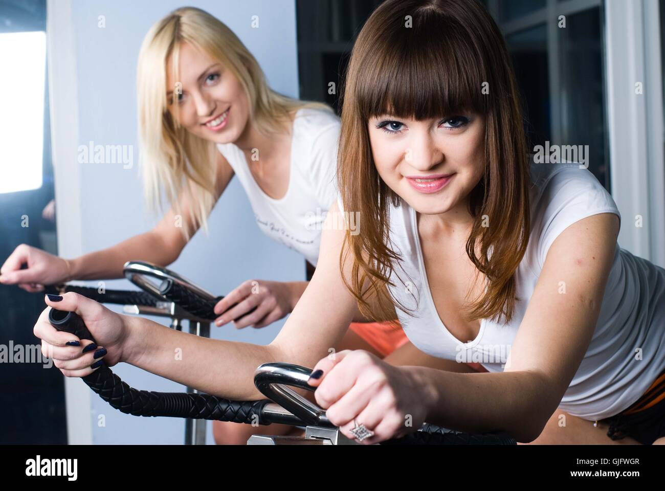 Attractive girls on bicycle Stock Photo - Alamy