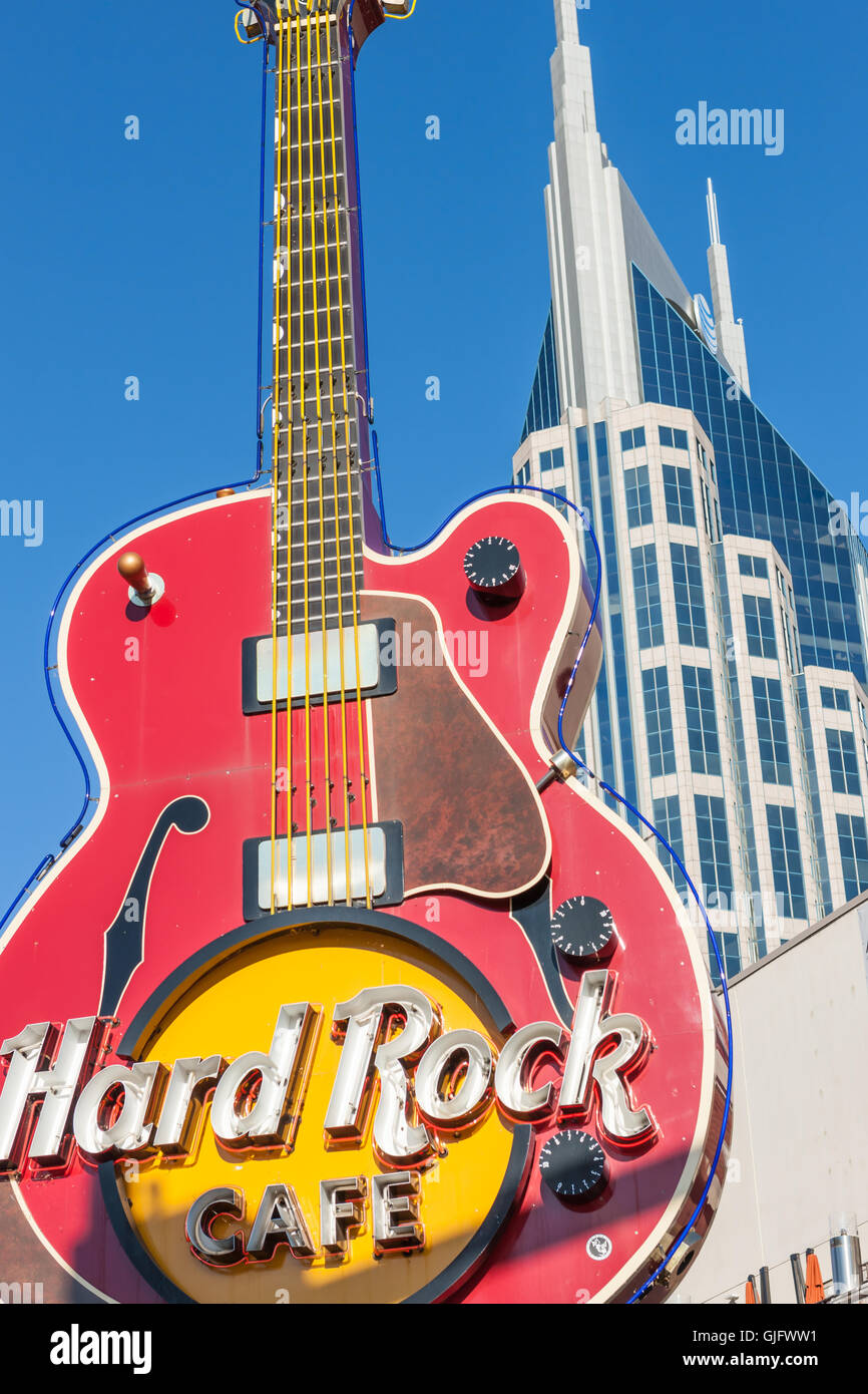A guitar shaped sign for the Hard Rock Cafe, with the AT&T Building in ...