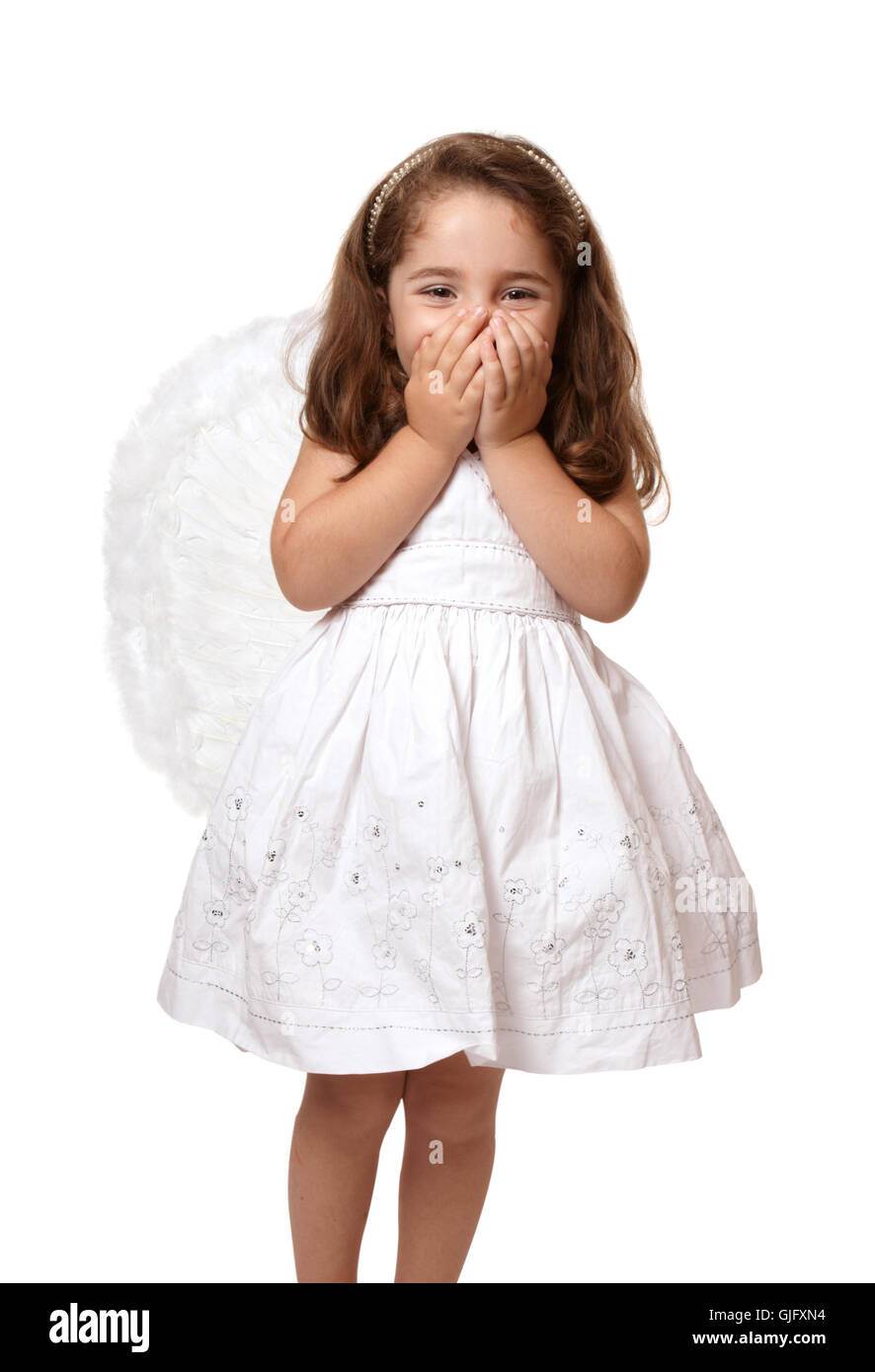 Little angel girl with hands covering her mouth Stock Photo - Alamy