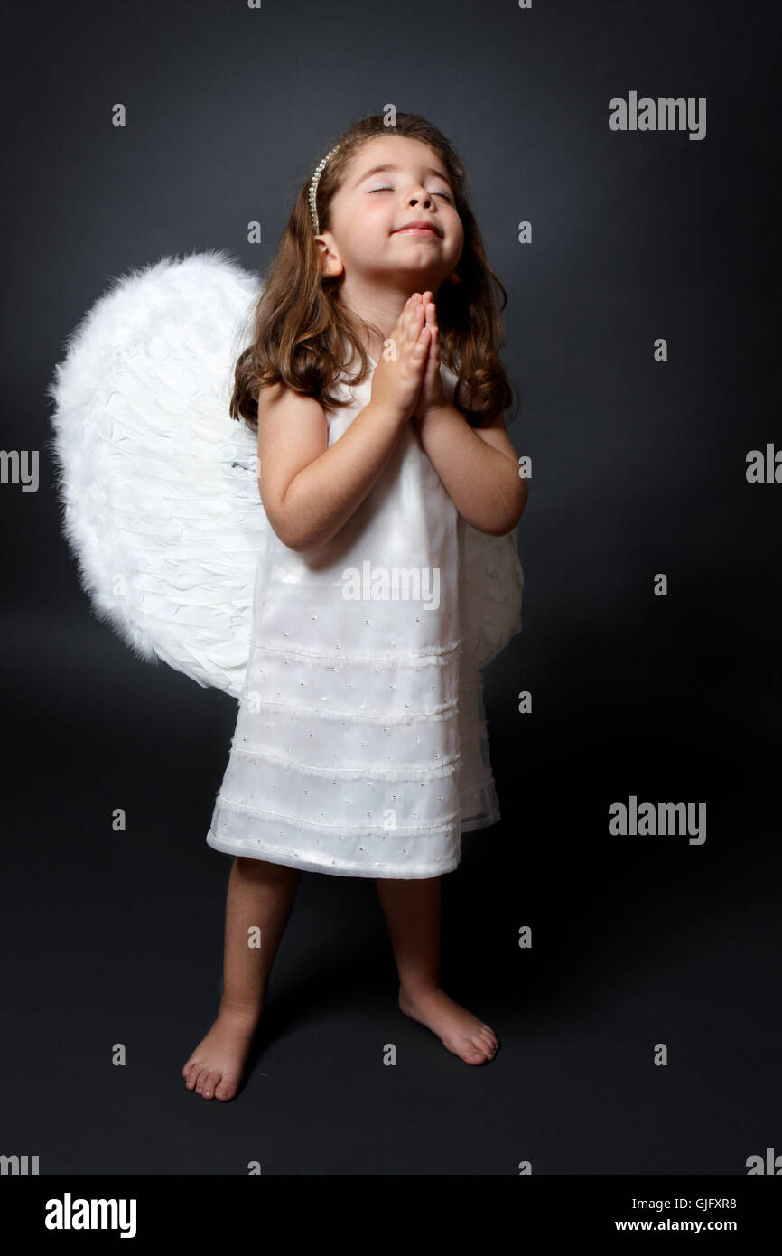 Praying angel with hands together in worship Stock Photo - Alamy