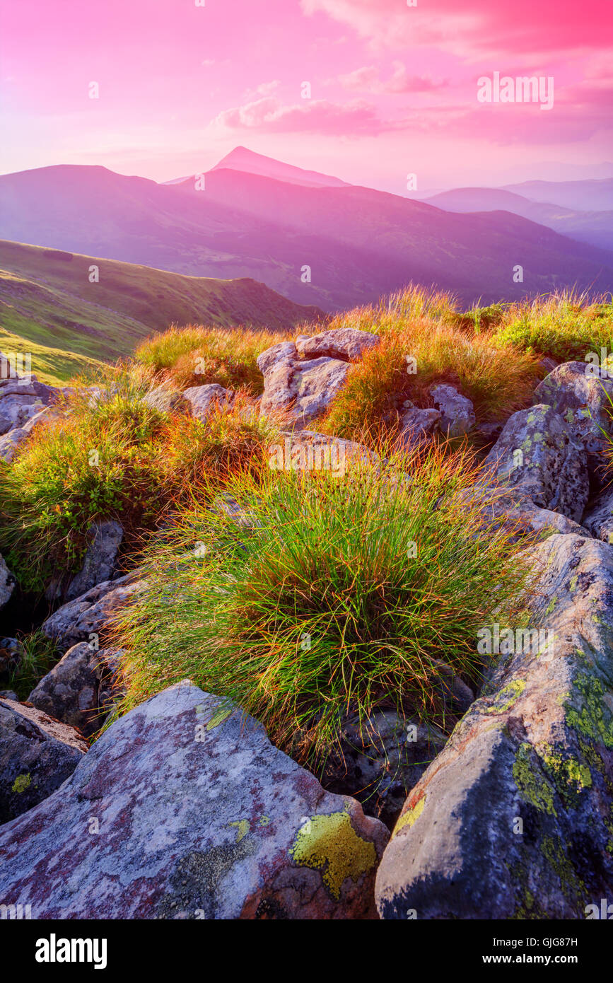 View of the stony hills glowing by evening sunlight. Dramatic autumn ...