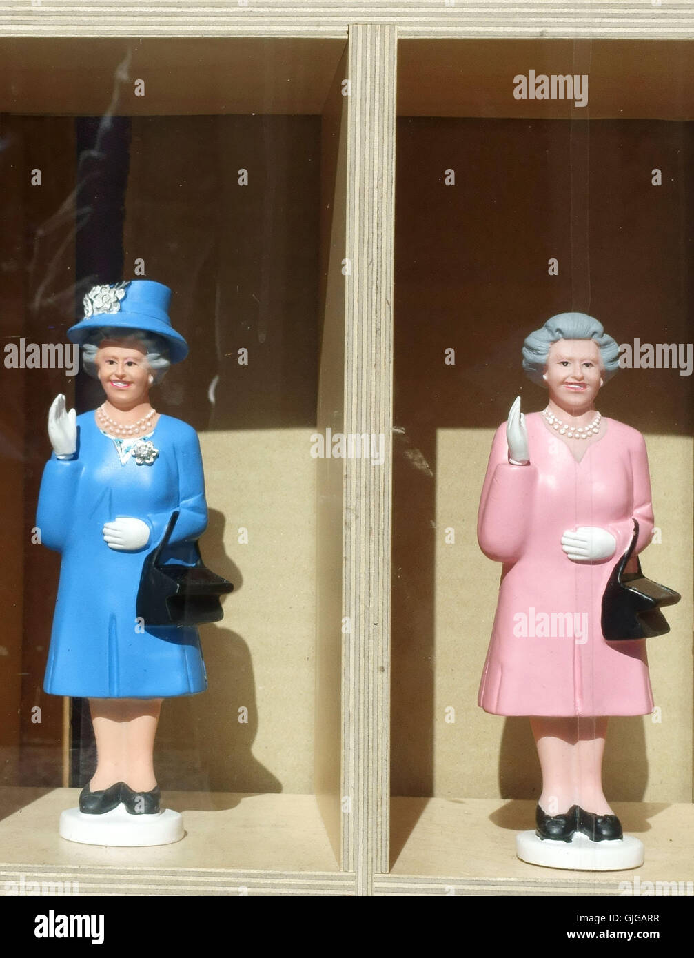 Animated waving HM Queen figures in souvenir shop window, London Stock ...