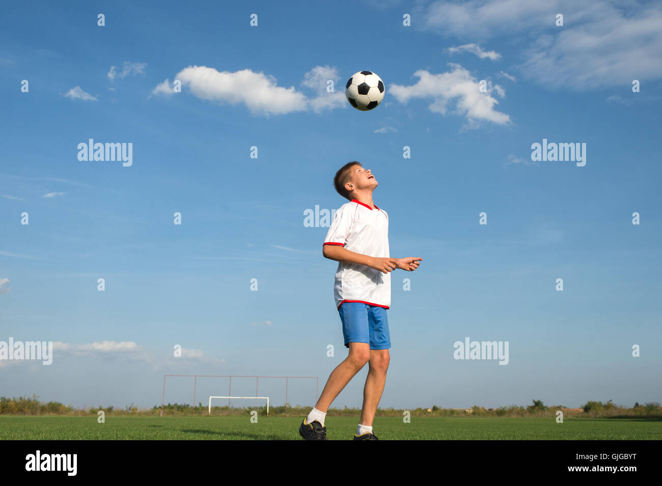 Kids playing football head hi-res stock photography and images - Alamy