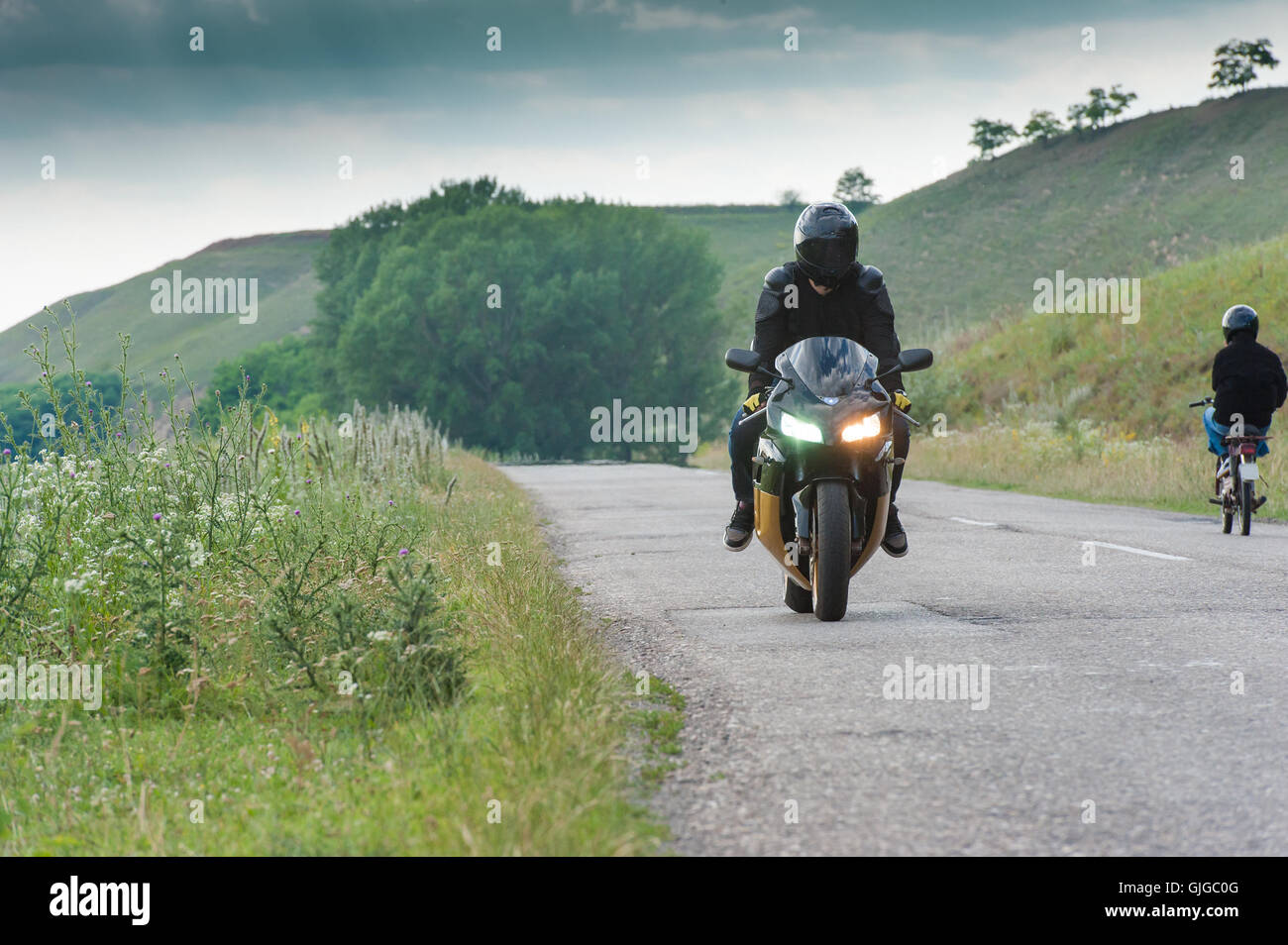 Biker man riding on a bike Stock Photo - Alamy