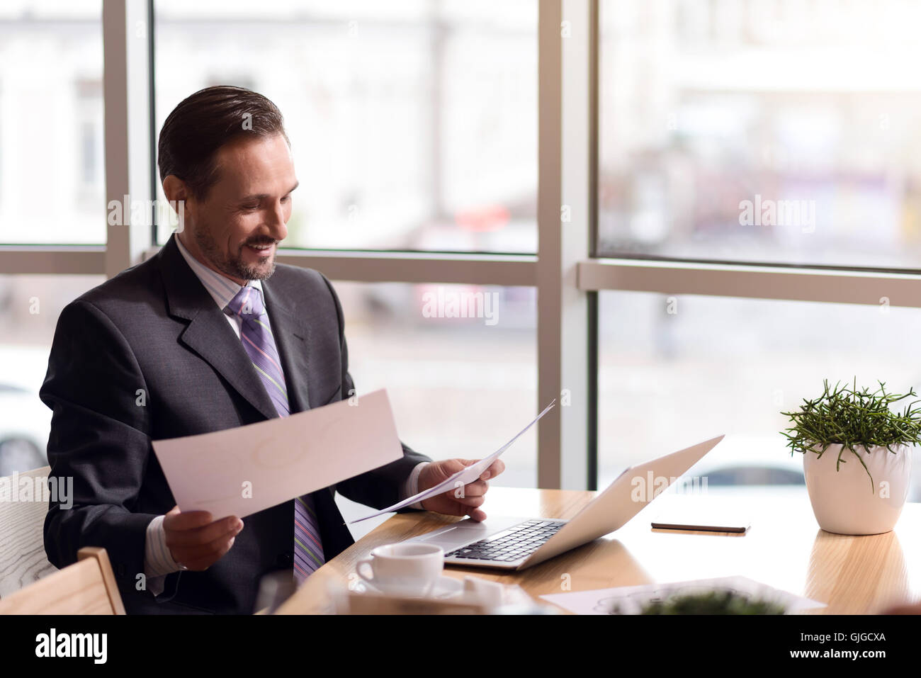 Joyful man working with paper Stock Photo - Alamy