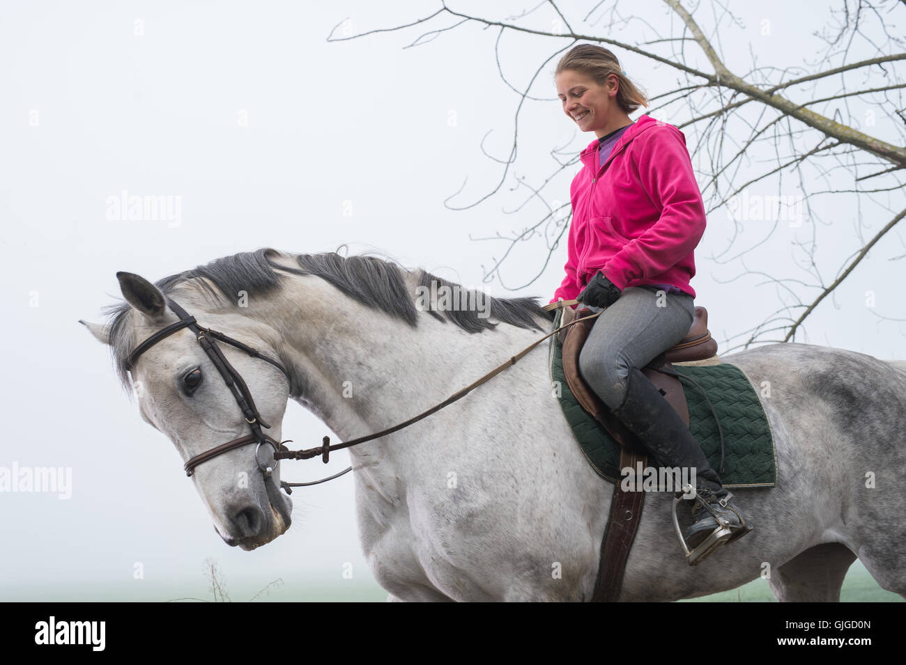 young woman riding in the fog Stock Photo - Alamy