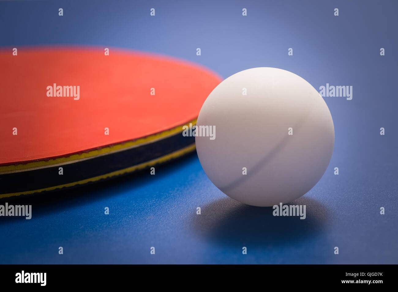 Tabletennis racket and ball on table Stock Photo - Alamy