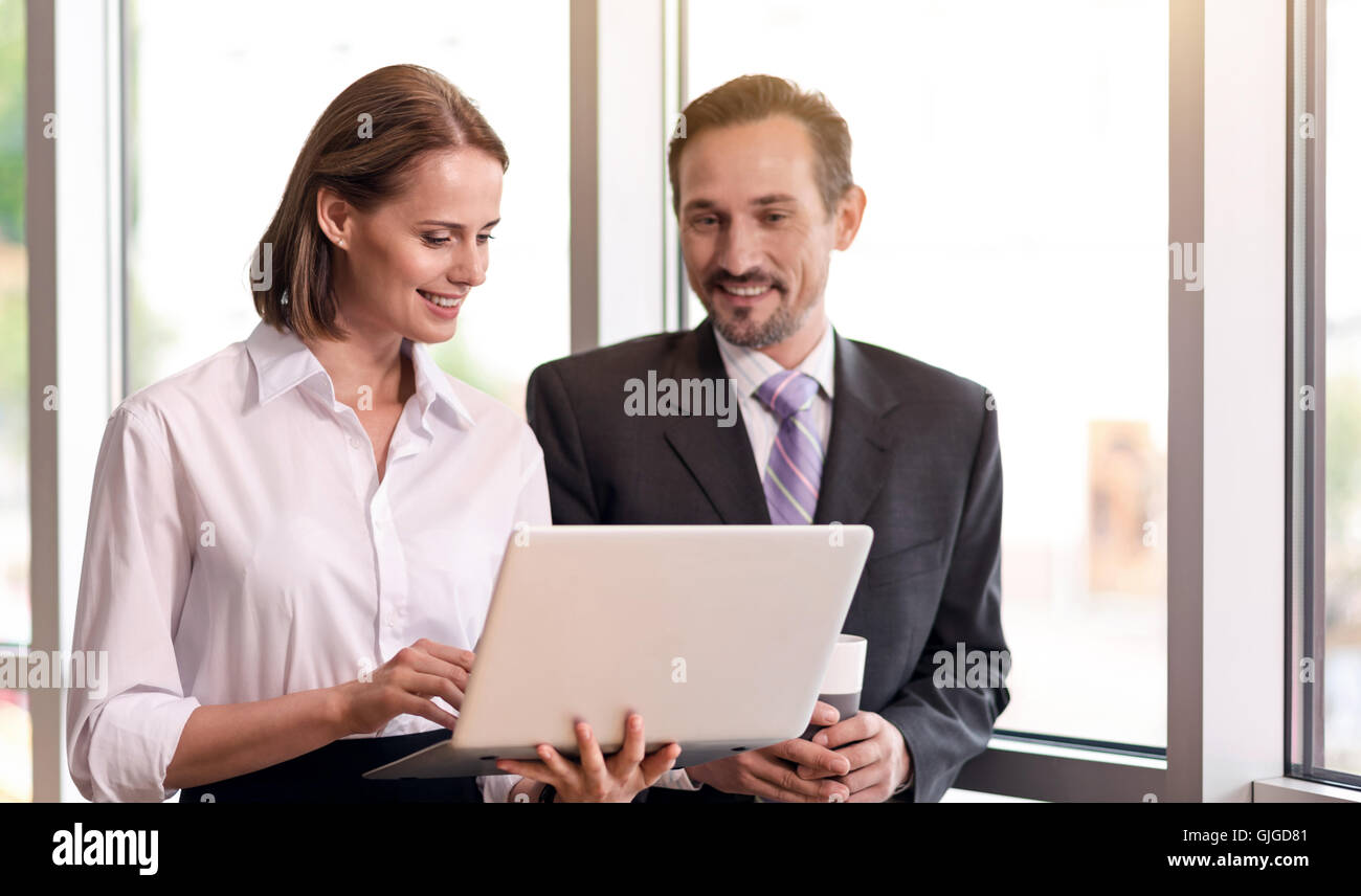 Colleagues laptop stand office hi-res stock photography and images - Alamy
