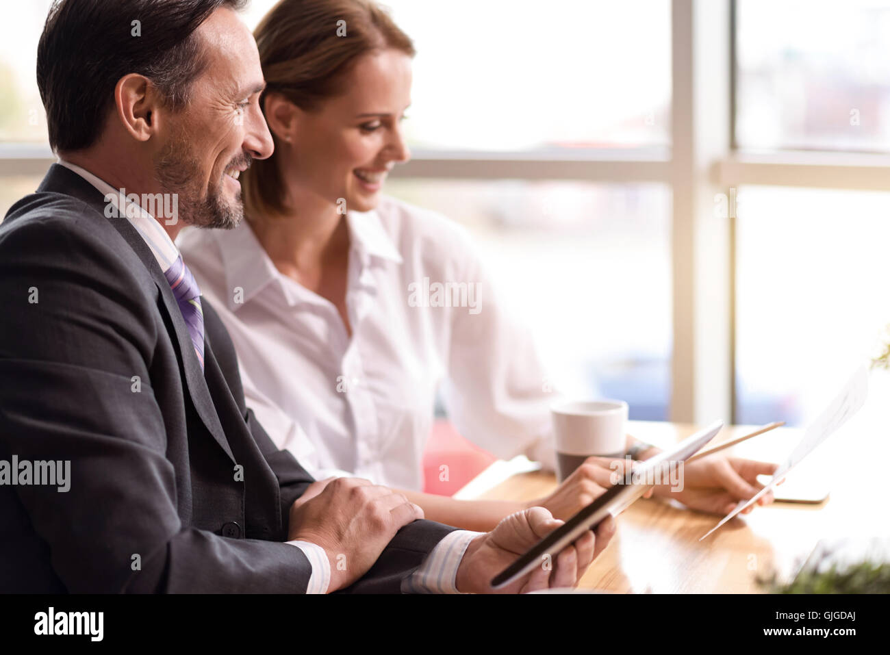 Cheerful colleagues sitting table hi-res stock photography and images ...