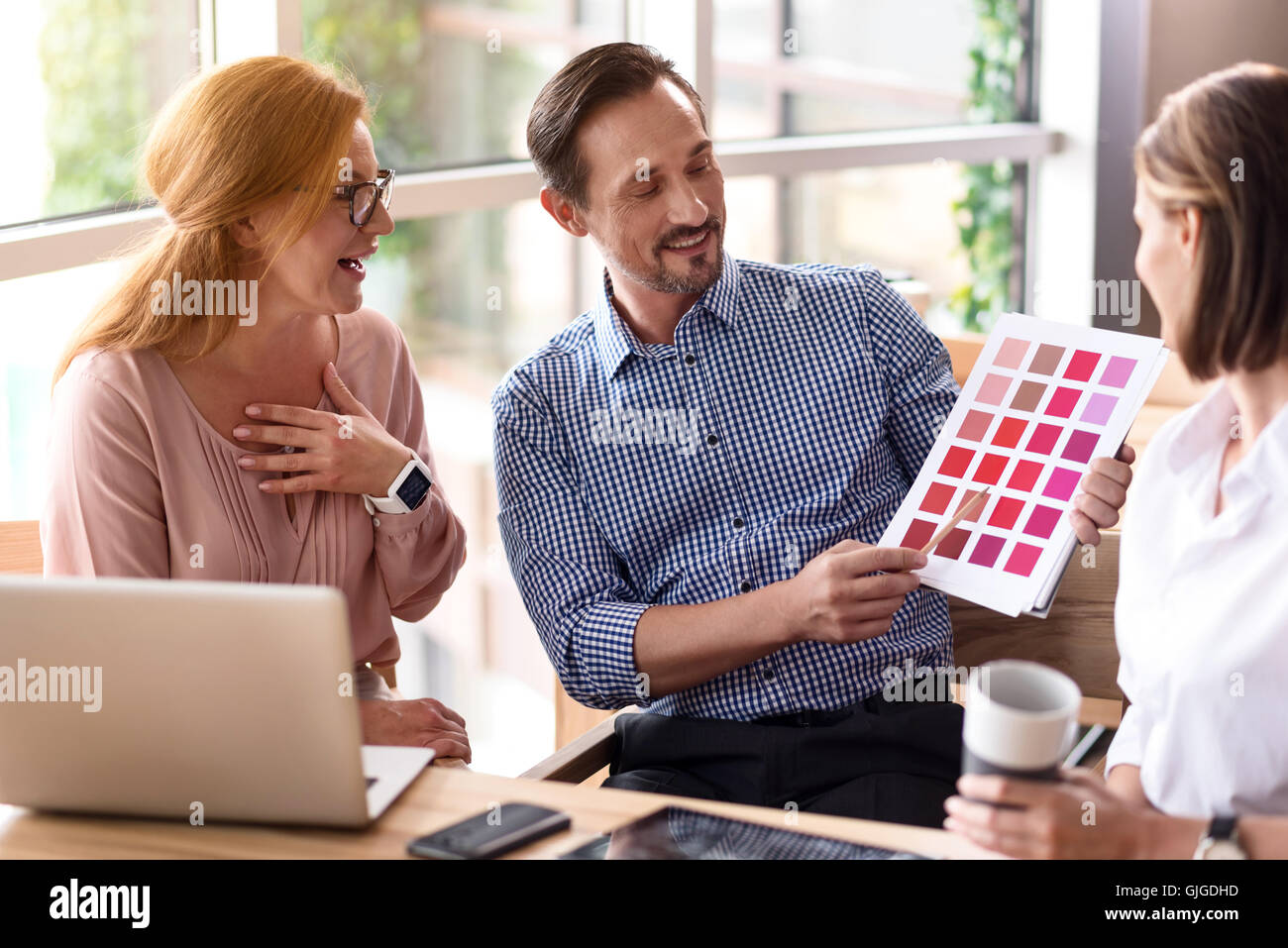 Positive colleagues choosing colors Stock Photo - Alamy