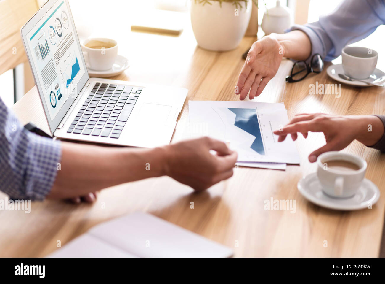 Pleasant colleagues working with the diagram Stock Photo - Alamy