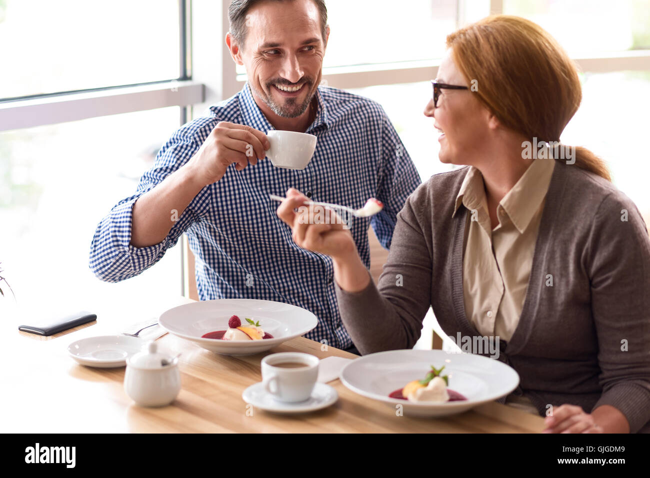 Joyful colleagues having a lunch Stock Photo - Alamy