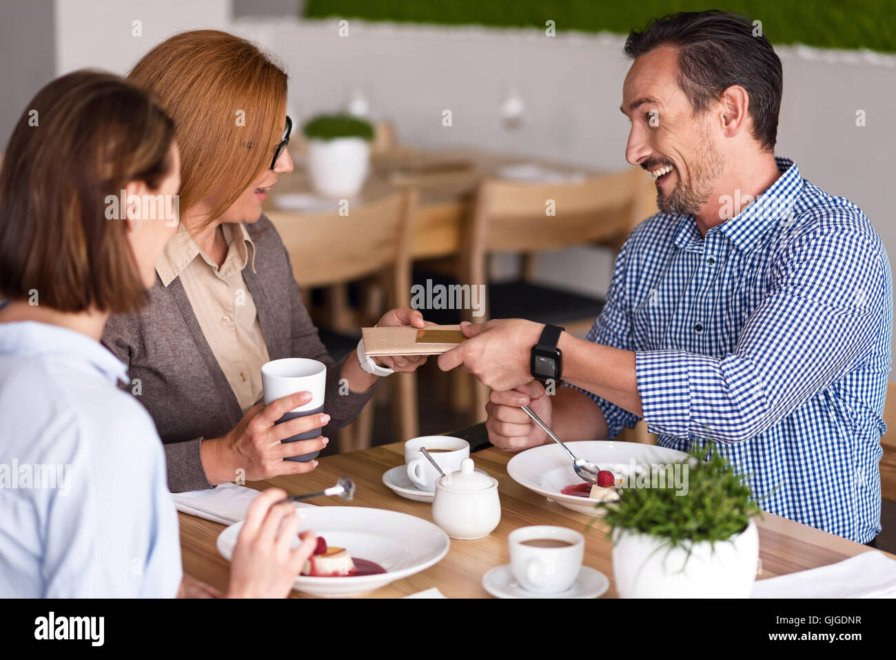 Cheerful colleagues having a lunch Stock Photo - Alamy