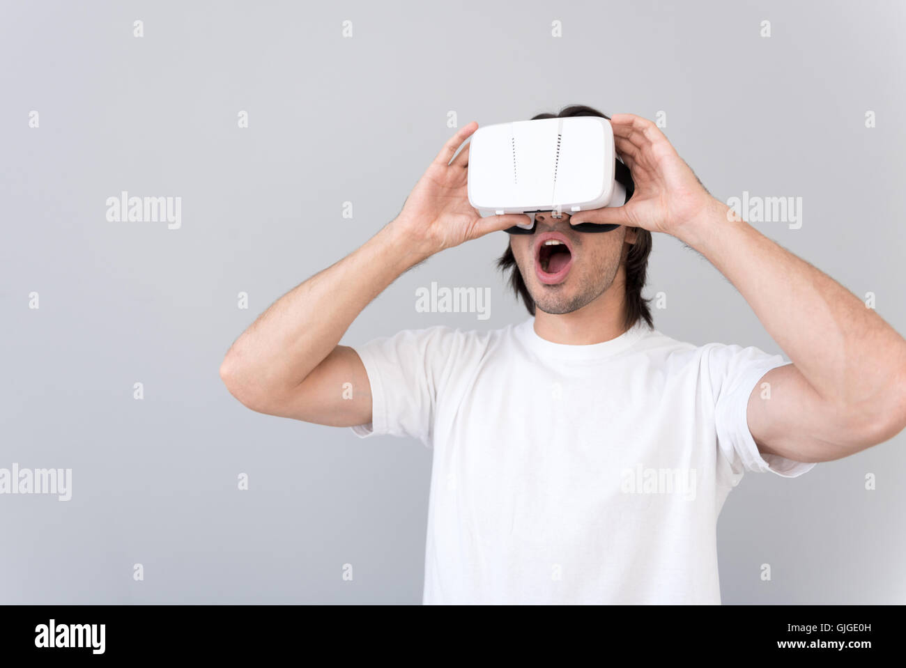 Cheerful man using virtual reality device Stock Photo - Alamy