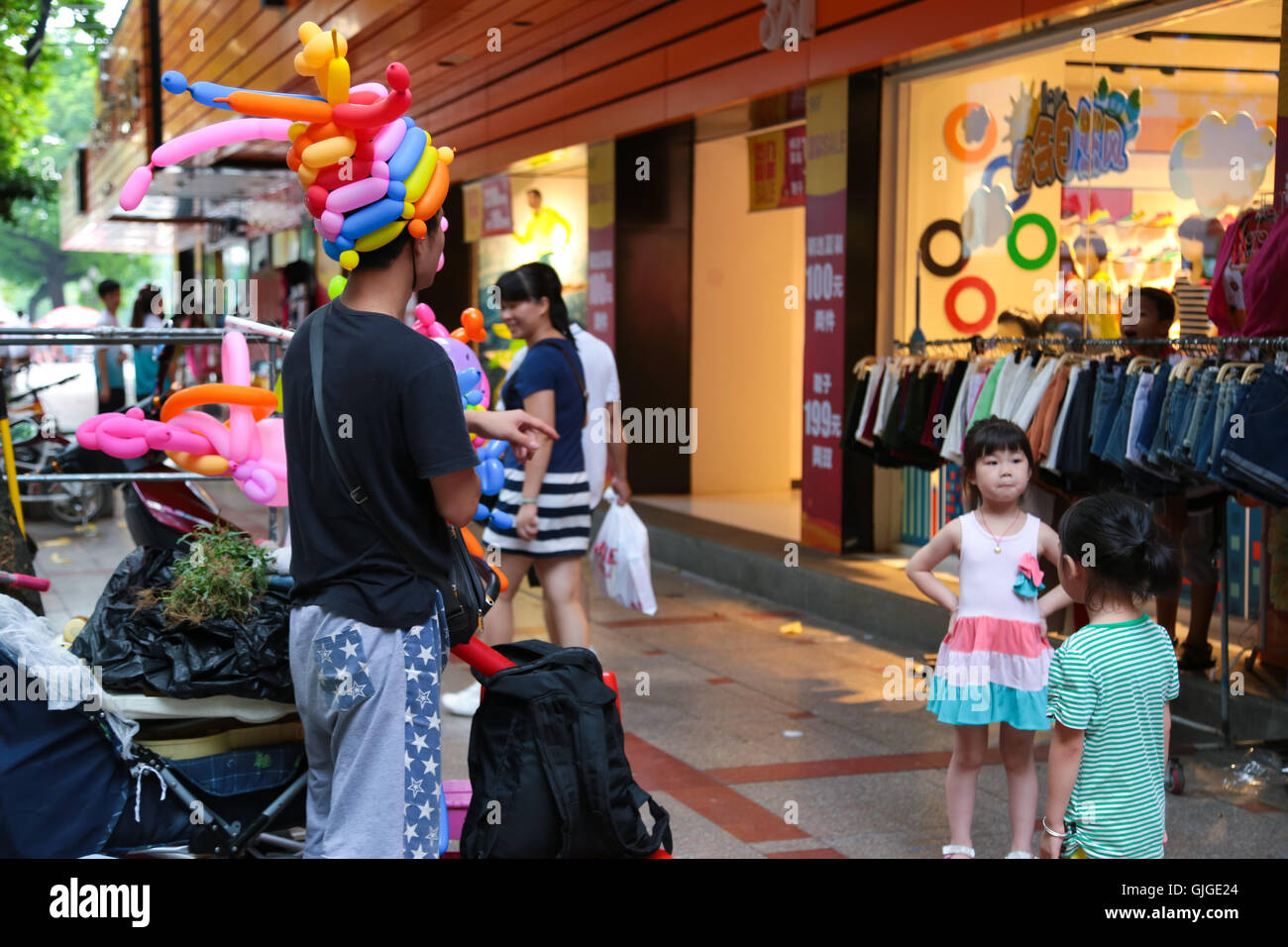 Clown selling his balloon making service at Huizhou shopping district ...