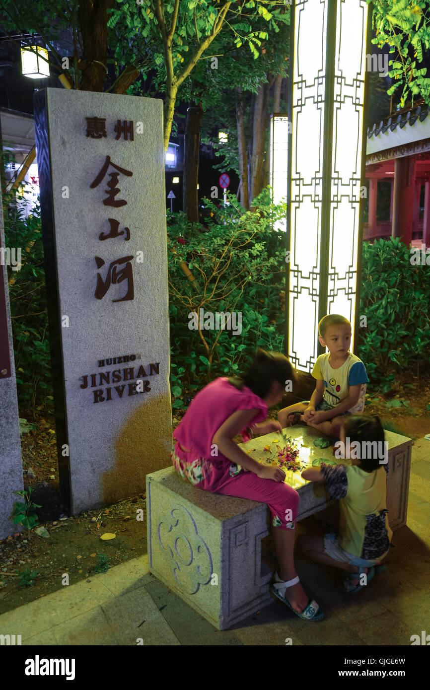 Chinese local children playing game at Jinshan river recreation park ...