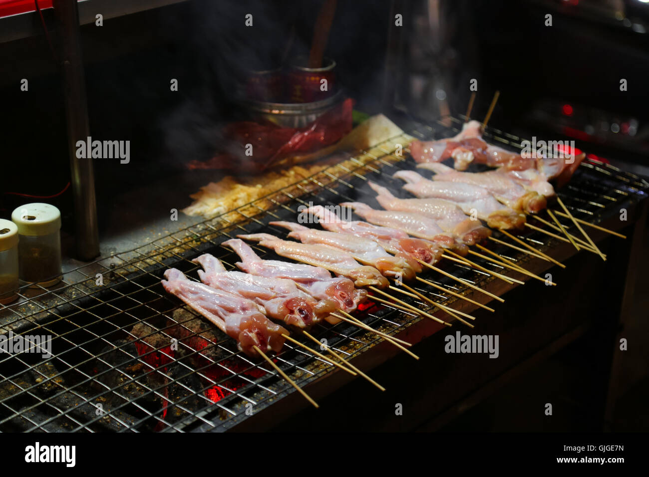 Stall selling barbecue chicken wing on the night street of Huizhou ...