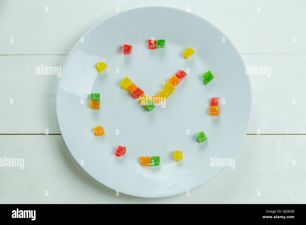 Fruit clock with candied fruits Stock Photo - Alamy