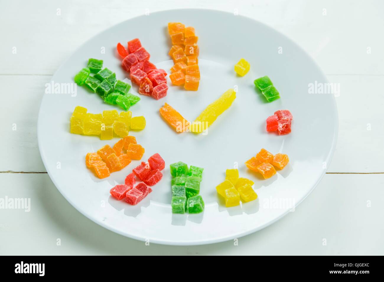 Fruit clock with candied fruits Stock Photo - Alamy