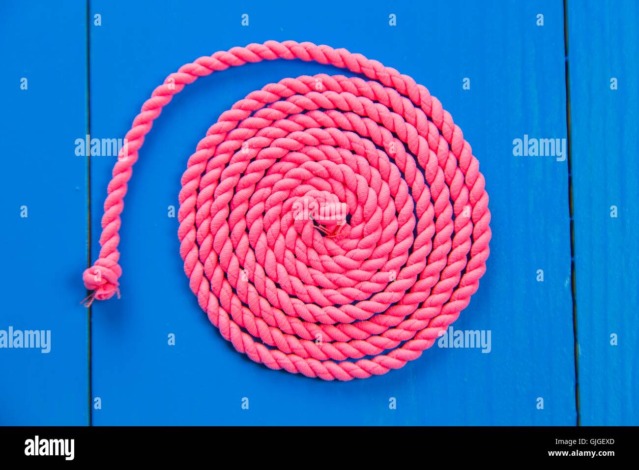 Pink rope circle on blue background Stock Photo - Alamy