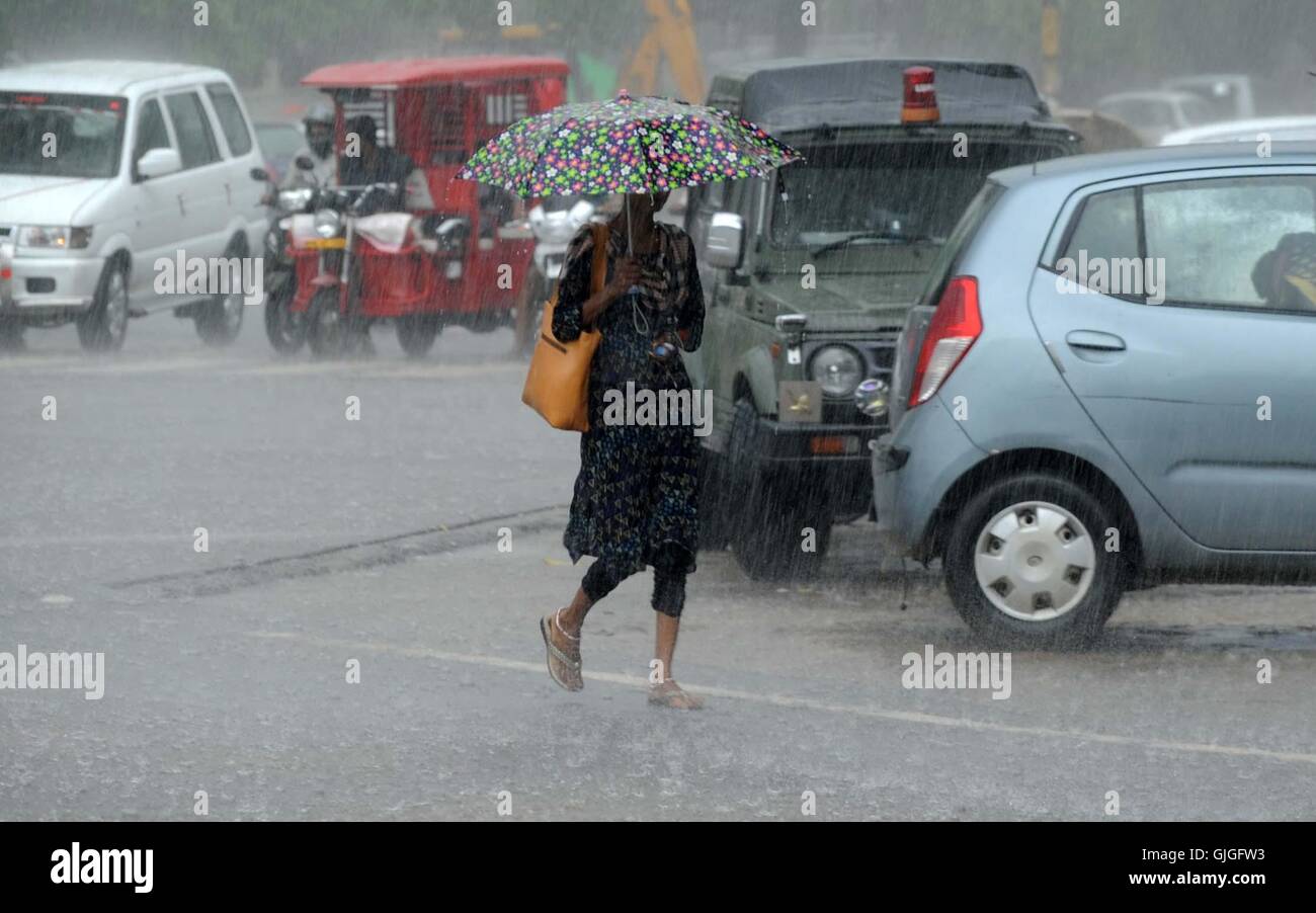 Allahabad, India. 16th Aug, 2016. A girl cross road during heavy rain ...