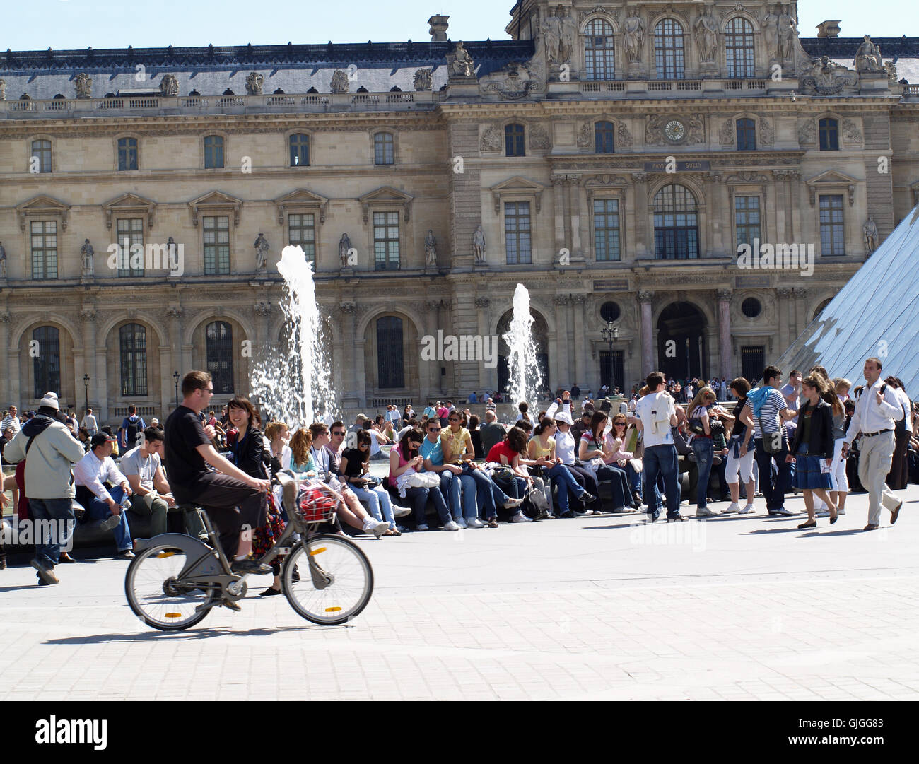 Crowds at Louvre Museum & Art Gallery, Paris, France, with man riding ...