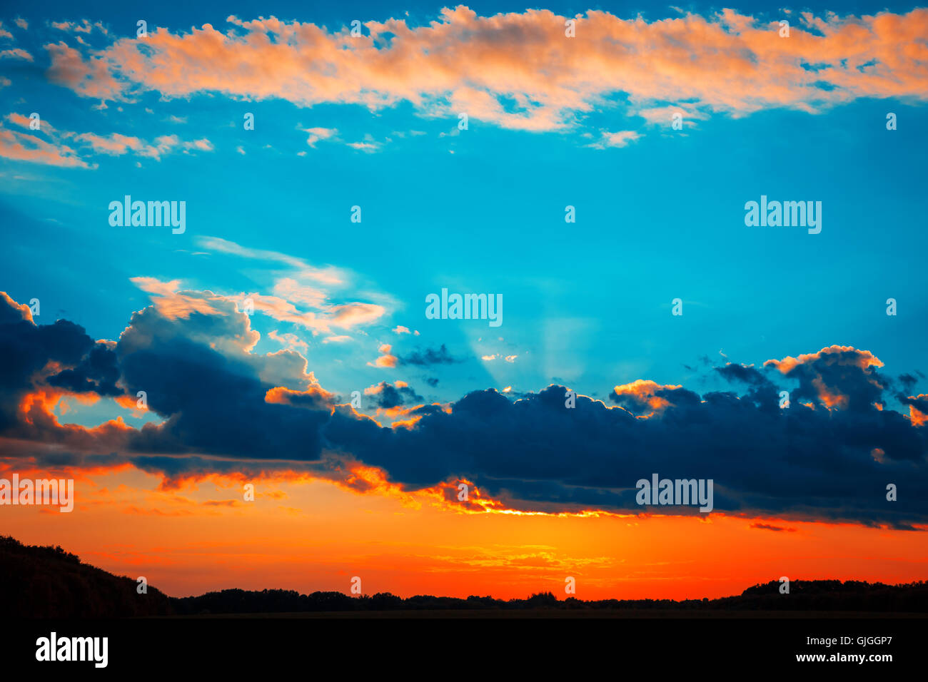 Beautiful blazing sunset landscape at over the meadow and orange sky ...