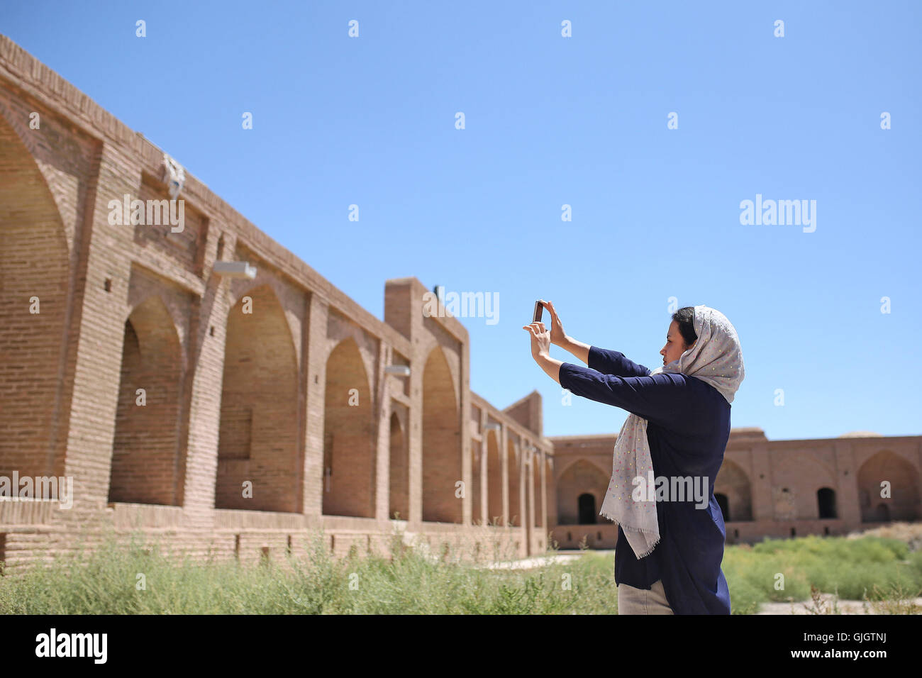 Semnan, Iran. 15th Aug, 2016. A tourist takes pictures of a historical ...