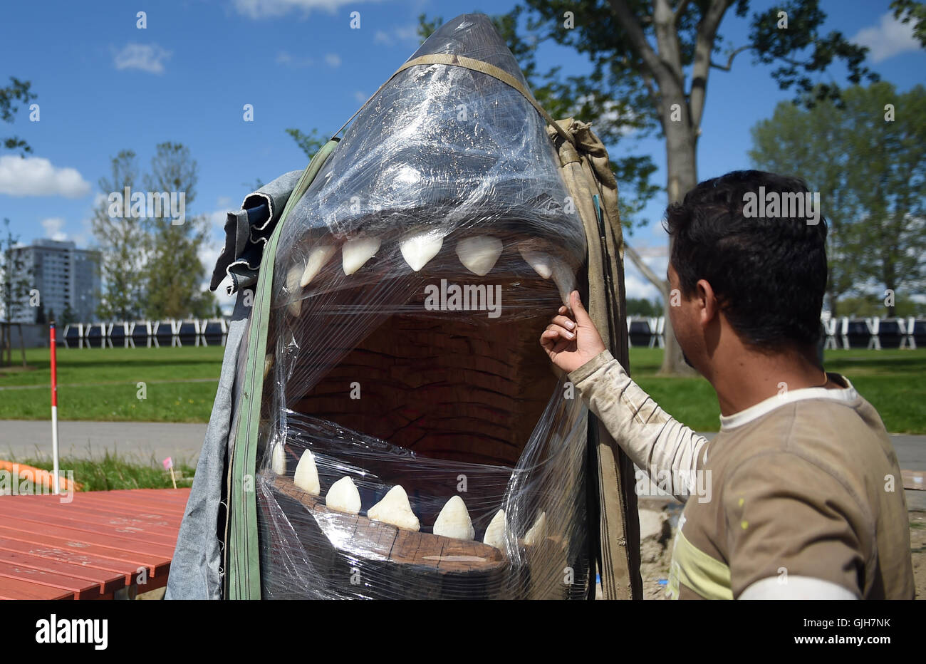 Berlin, Germany. 17th Aug, 2016. Intern Adam unpacking a shark head ...
