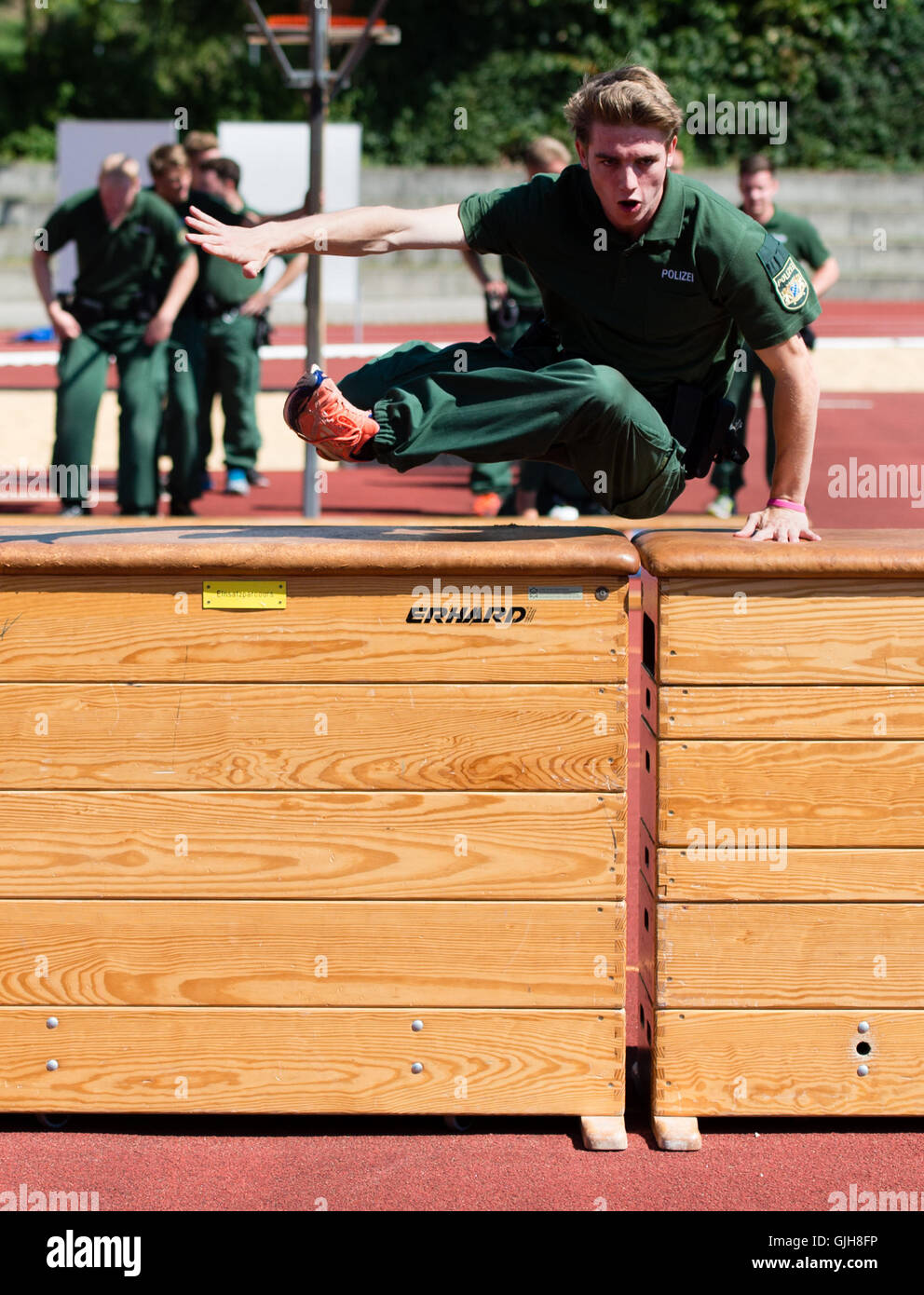 David Renz, police sergeant trainee, jumping over a hurdle during ...