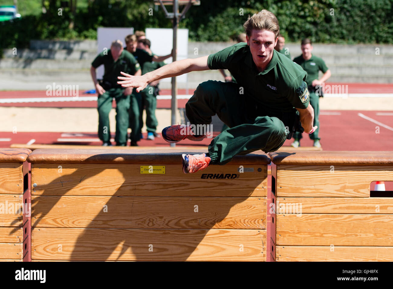David Renz, police sergeant trainee, jumping over a hurdle during ...