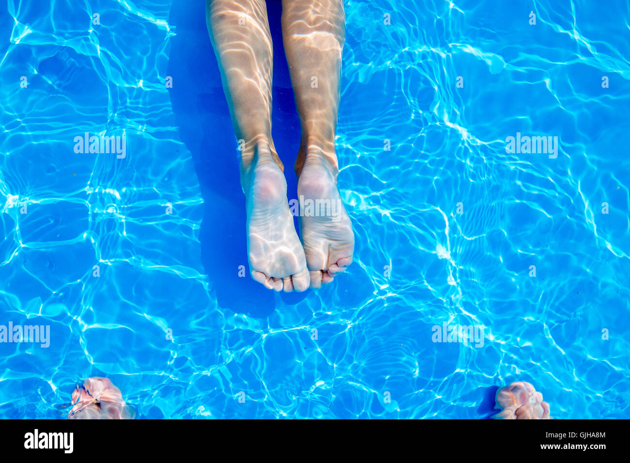 Young womans legs in swimming pool. Summer heat Stock Photo - Alamy
