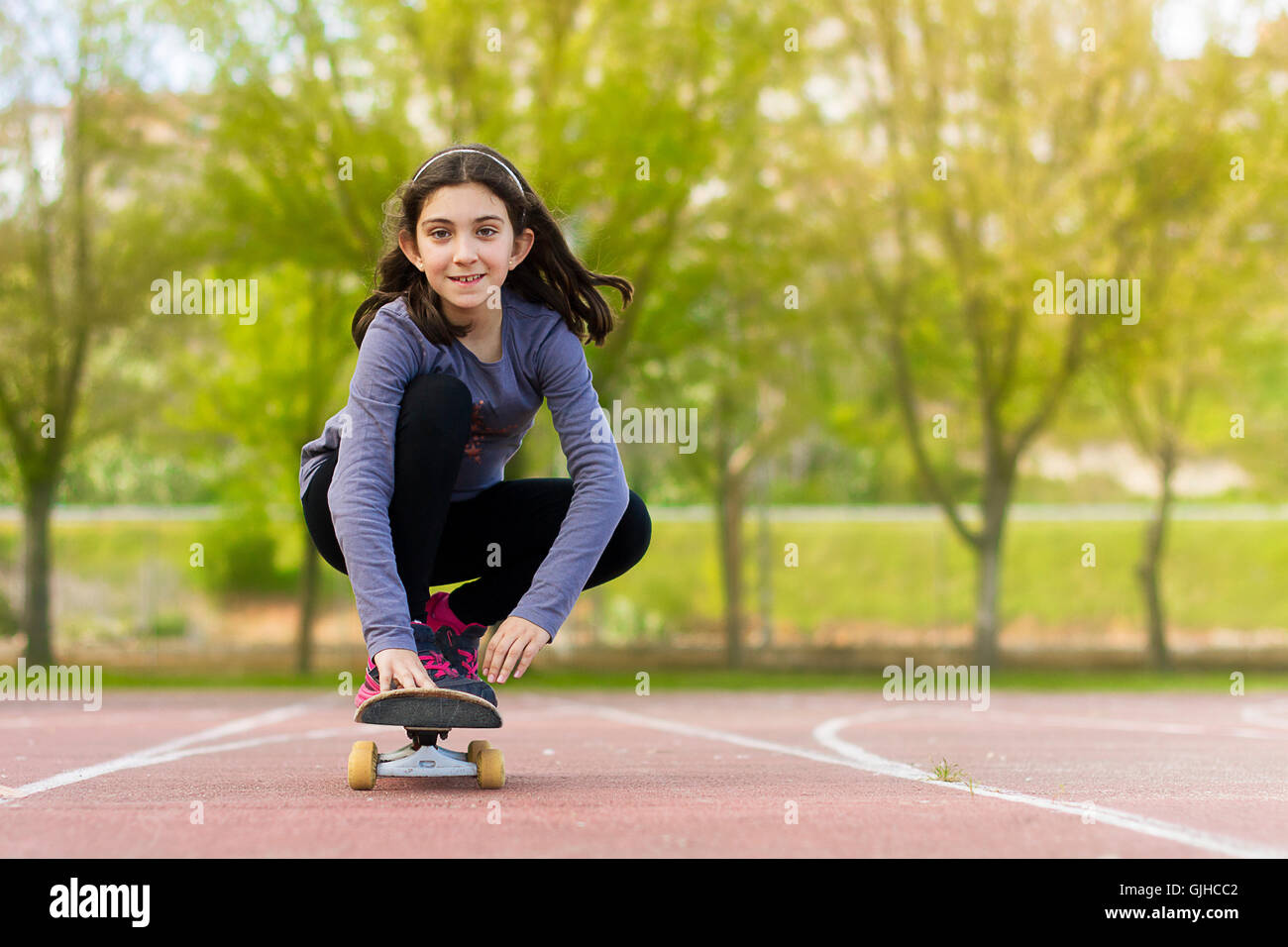Girl skateboarding in park Stock Photo - Alamy