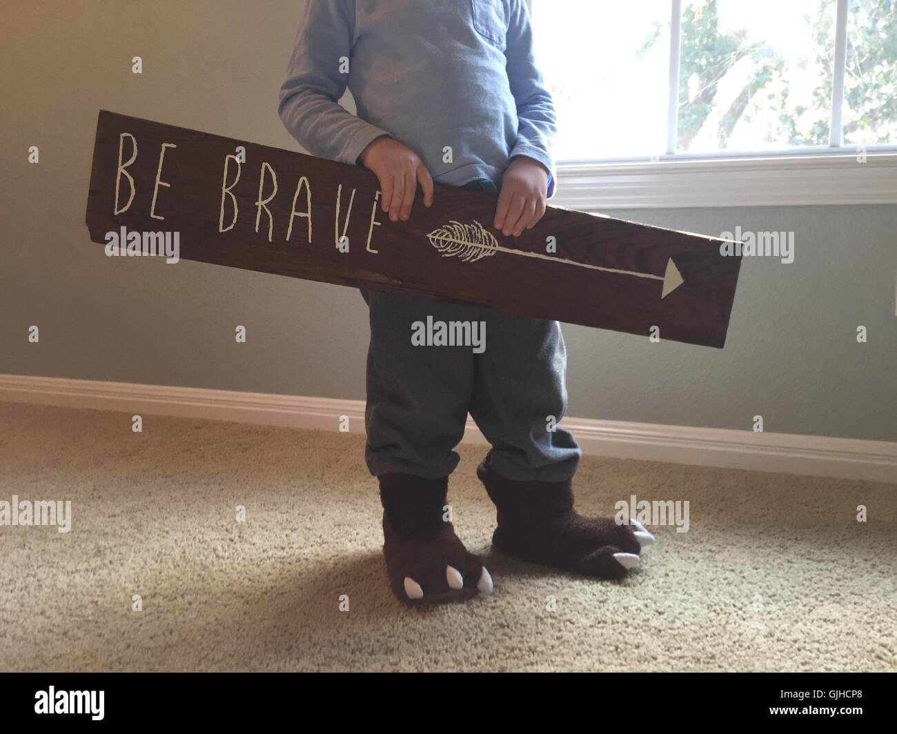 boy holding "Be Brave" sign Stock Photo - Alamy