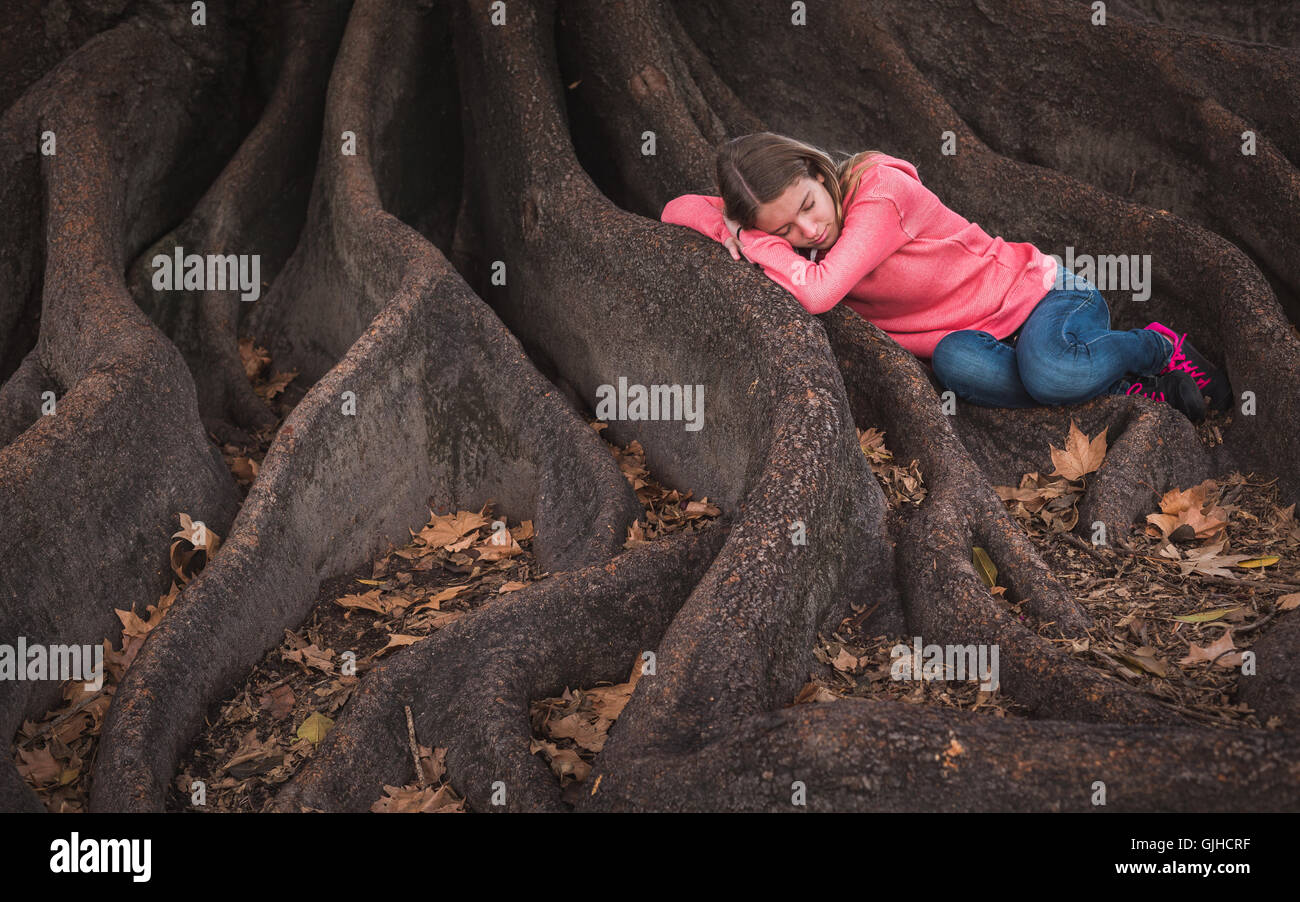 Girl lying on fig tree roots sleeping, Perth's Hyde Park, Perth ...