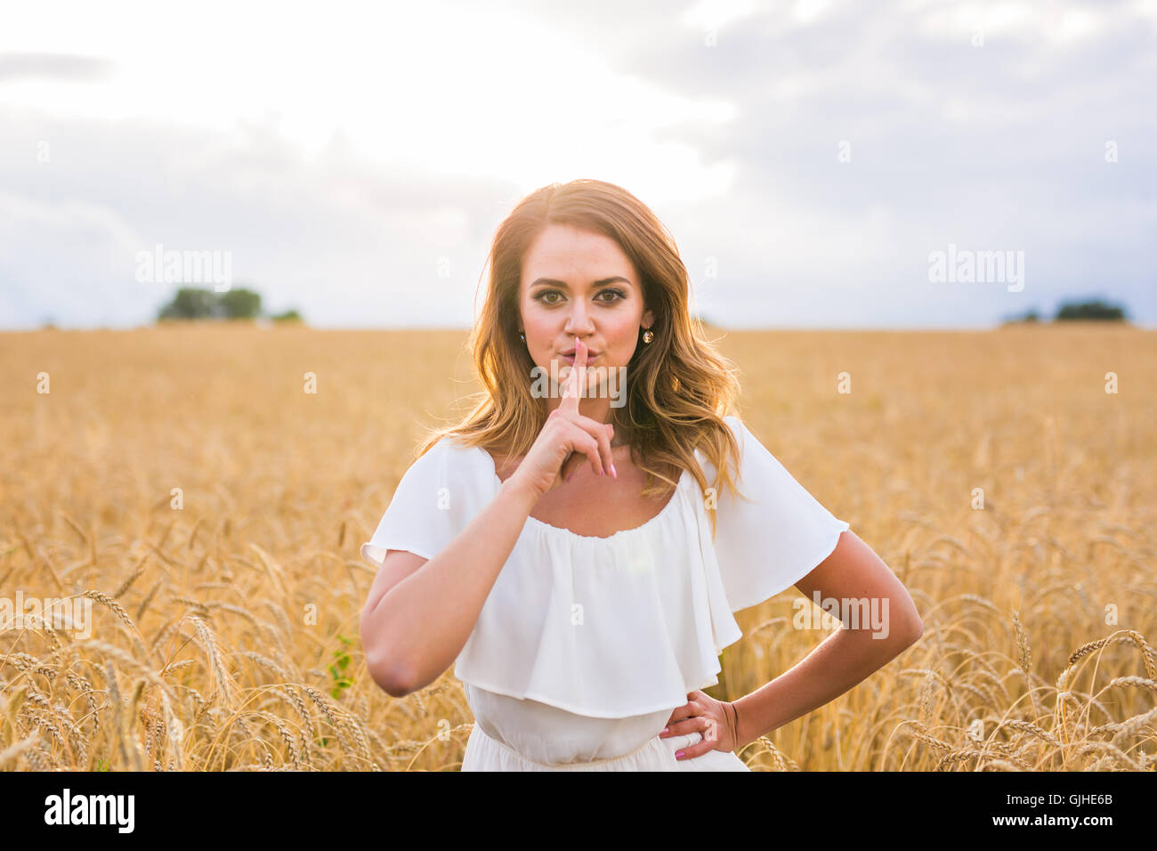 Quiet, secret and trust concept. Woman hand with silence sign symbol on ...
