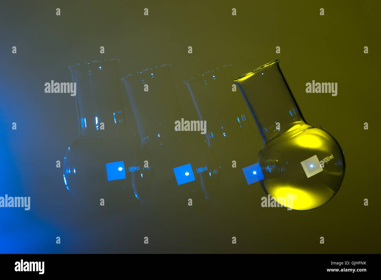 chemical flask in yellow stroboscope light Stock Photo - Alamy