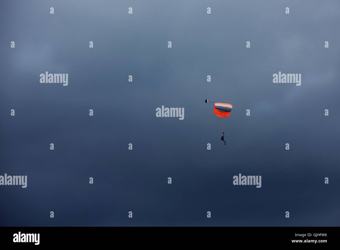 Man paragliding mid air Stock Photo - Alamy