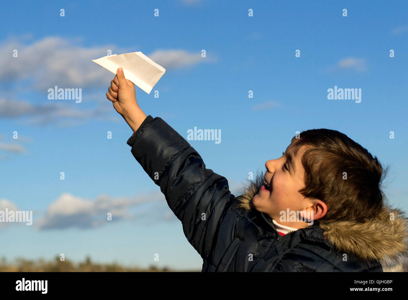 Boy playing with a paper airplane Stock Photo - Alamy