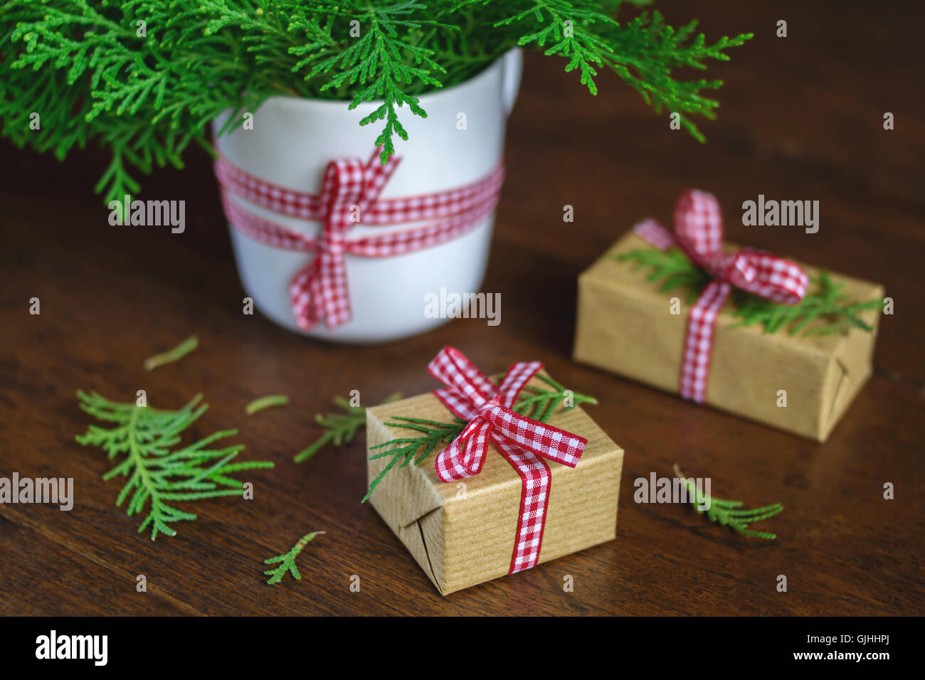 Christmas gift boxes decorated with green juniper Stock Photo - Alamy