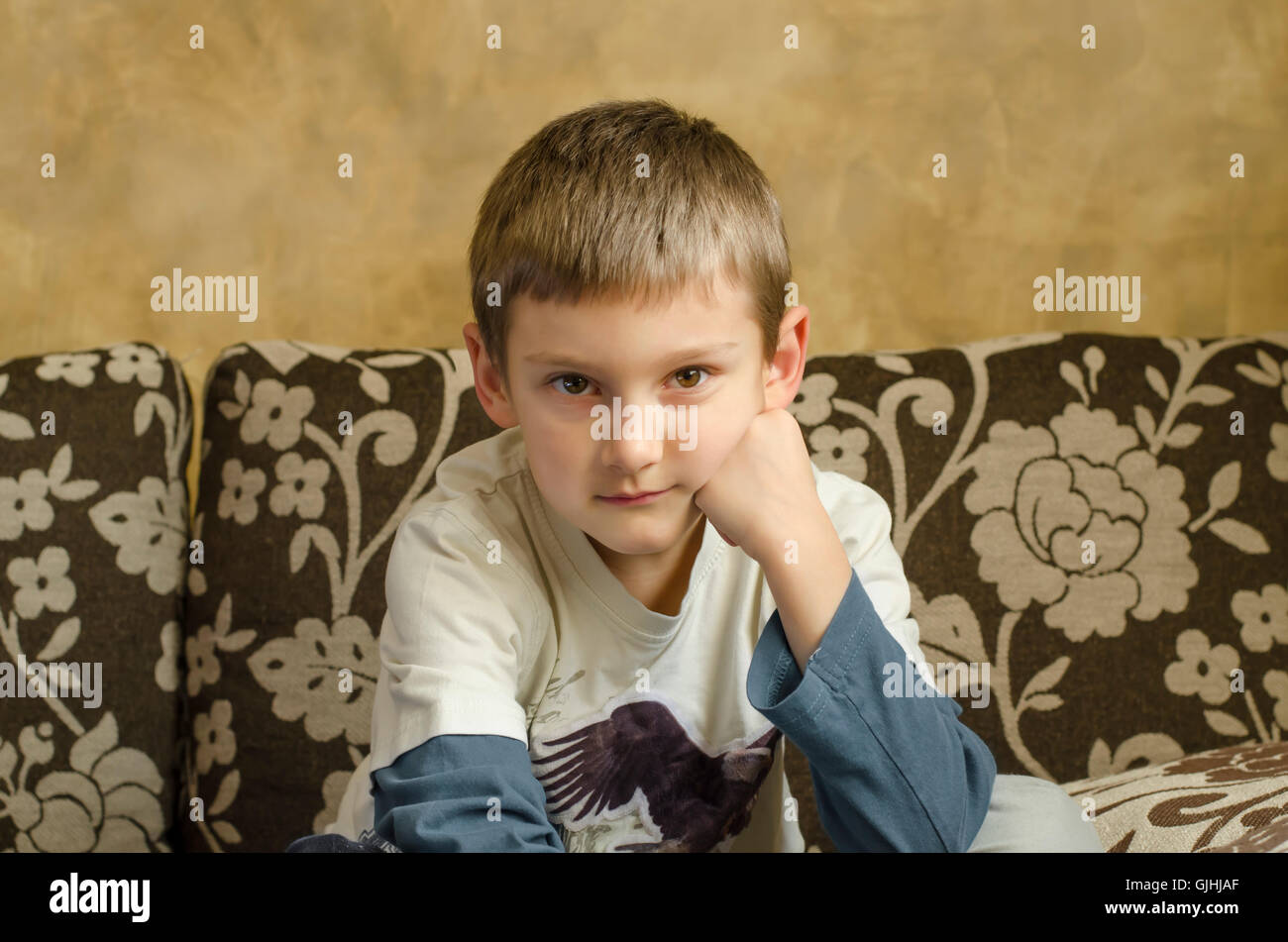 Portrait of a boy with hand on face Stock Photo - Alamy