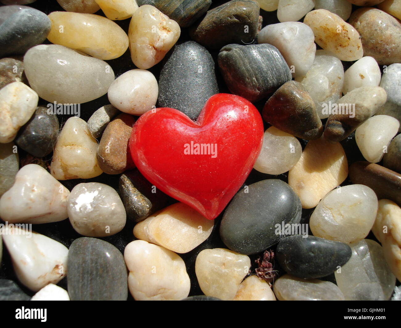 red heart stone on stones Stock Photo - Alamy