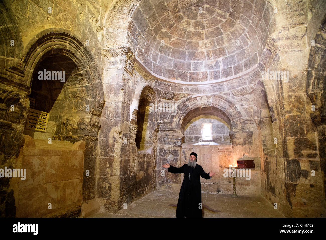 Priest prays in Deyrulzafaran orthodox Syriac monastery in Mardin Stock ...