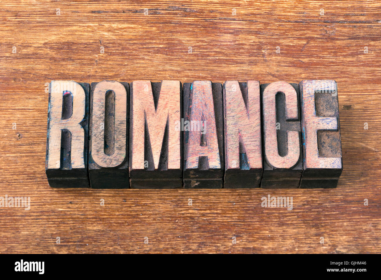 romance word made from wooden letterpress type on grunge wood Stock ...