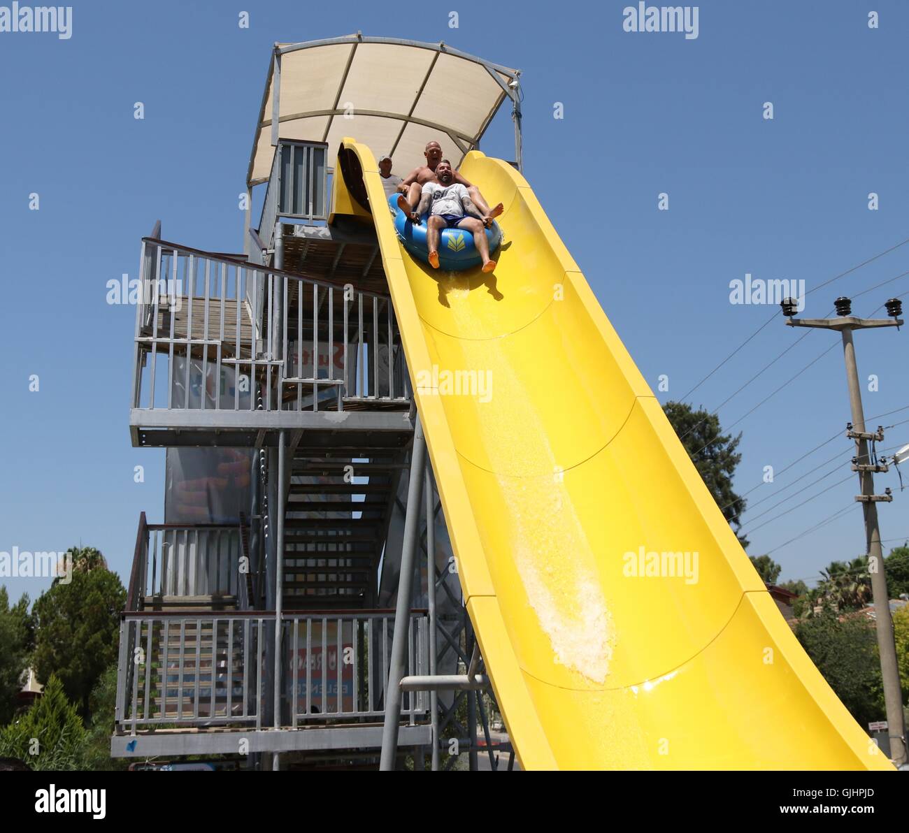 Two English tourists having fun on a water slide in a waterpark in ...