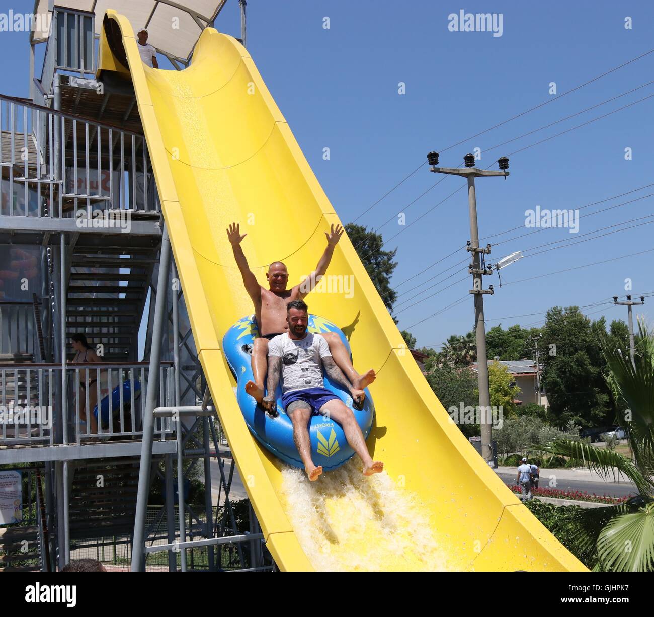 Two English tourists having fun on a water slide in a waterpark in ...