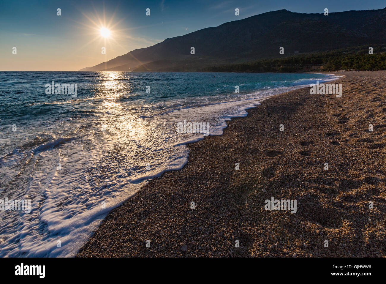 Backlight at sunset. Adriatic sea wave. Zlatni Rat beach. Bol, island ...
