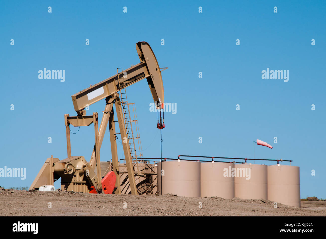 Oil Well Pump and Storage Tanks. Copy space Stock Photo - Alamy